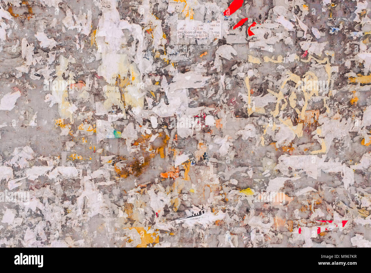 Old wall with remains of paper ads as background Stock Photo - Alamy