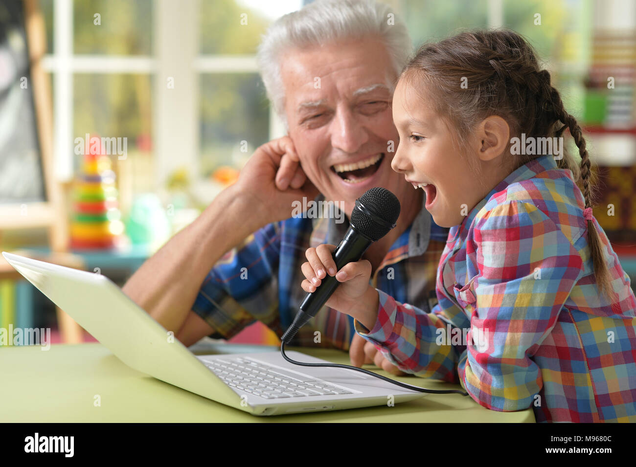 Portrait of happy grandfather and child singing karaoke Stock Photo - Alamy