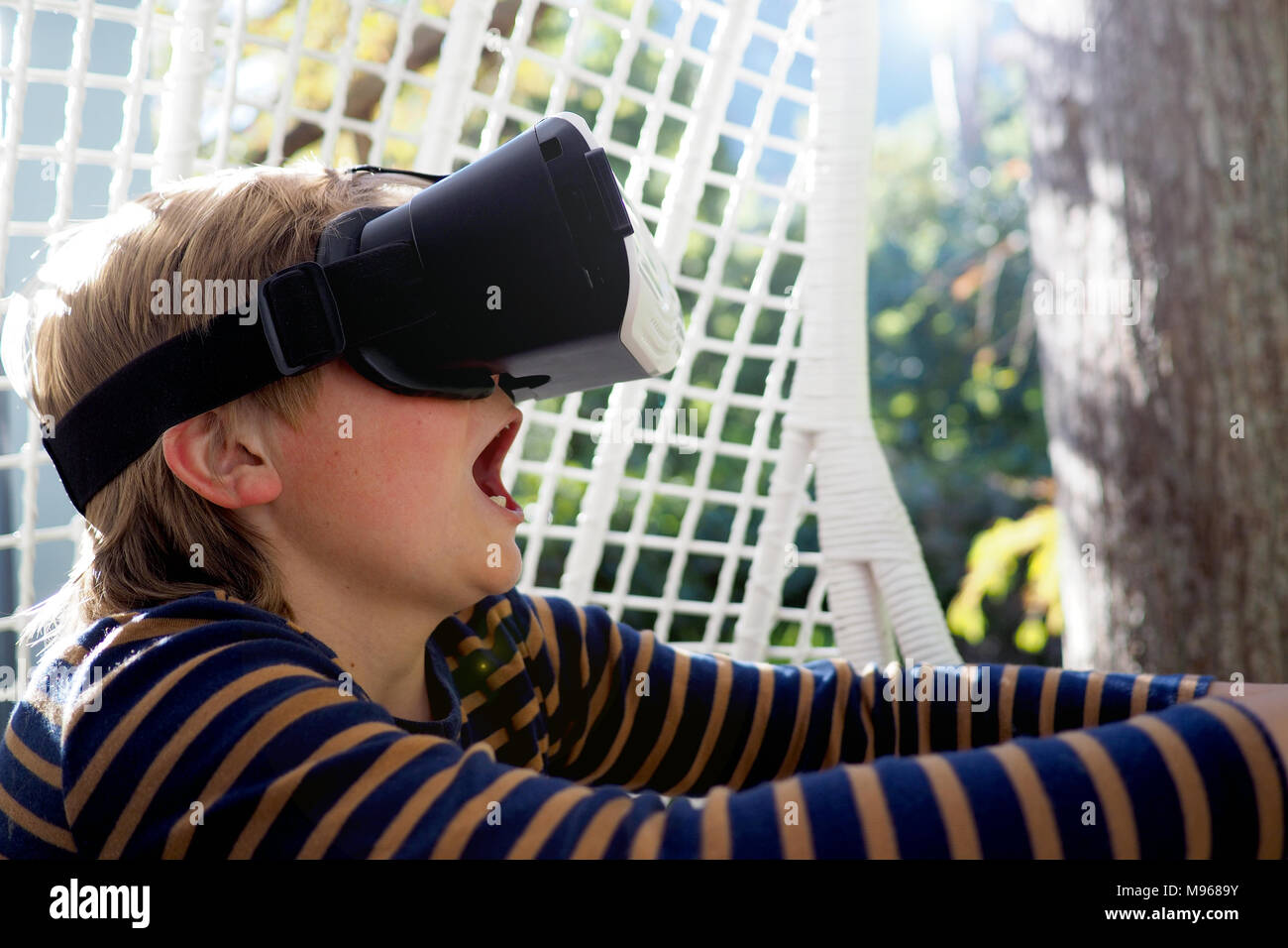 Young boy using VR goggles Stock Photo - Alamy