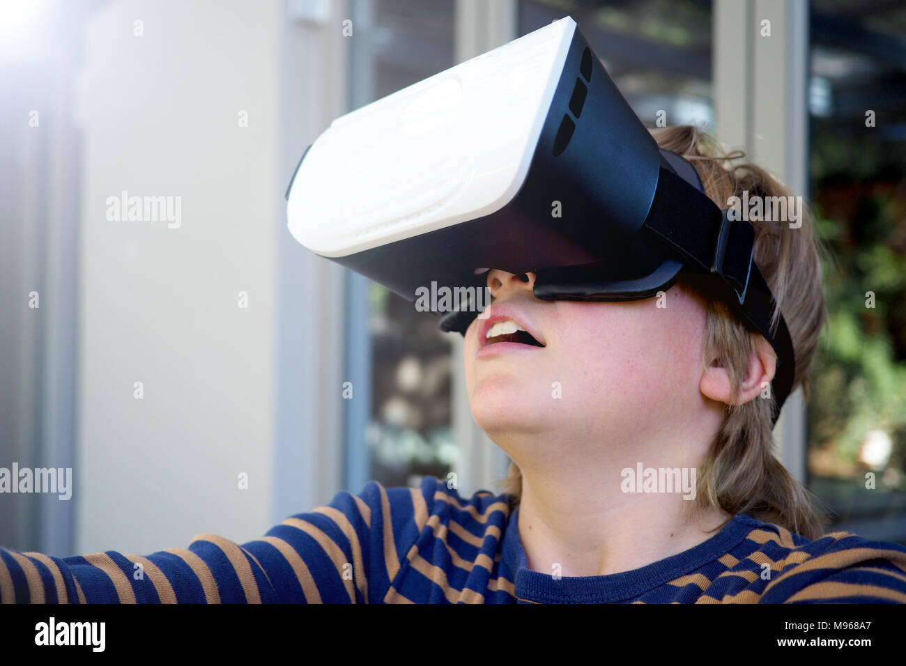 Young boy using VR goggles Stock Photo - Alamy