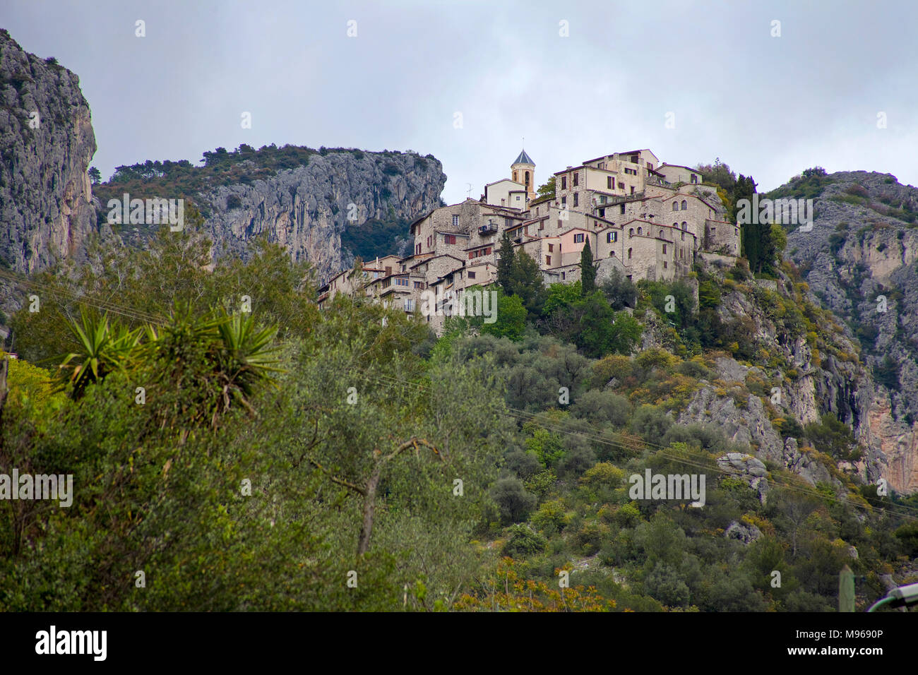 The fortified medieval village Peillon clings to a cliff face ...