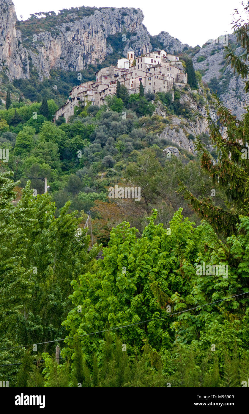 The fortified medieval village Peillon clings to a cliff face ...