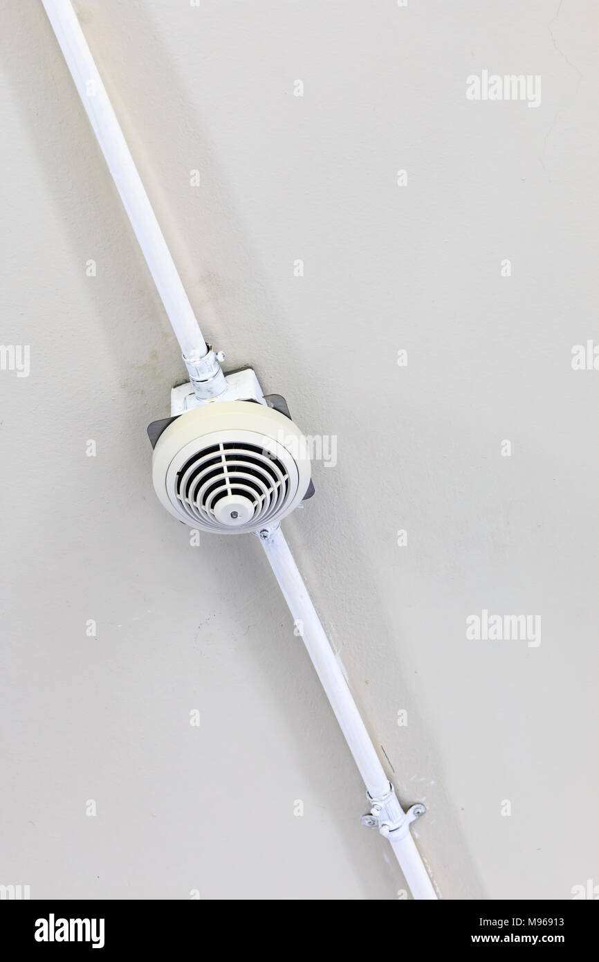 Smoke detector on cement ceiling Stock Photo - Alamy