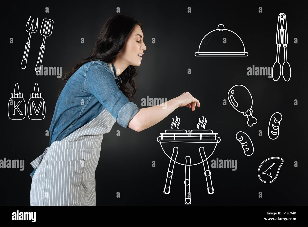 Attentive woman adding salt while making a barbeque Stock Photo - Alamy