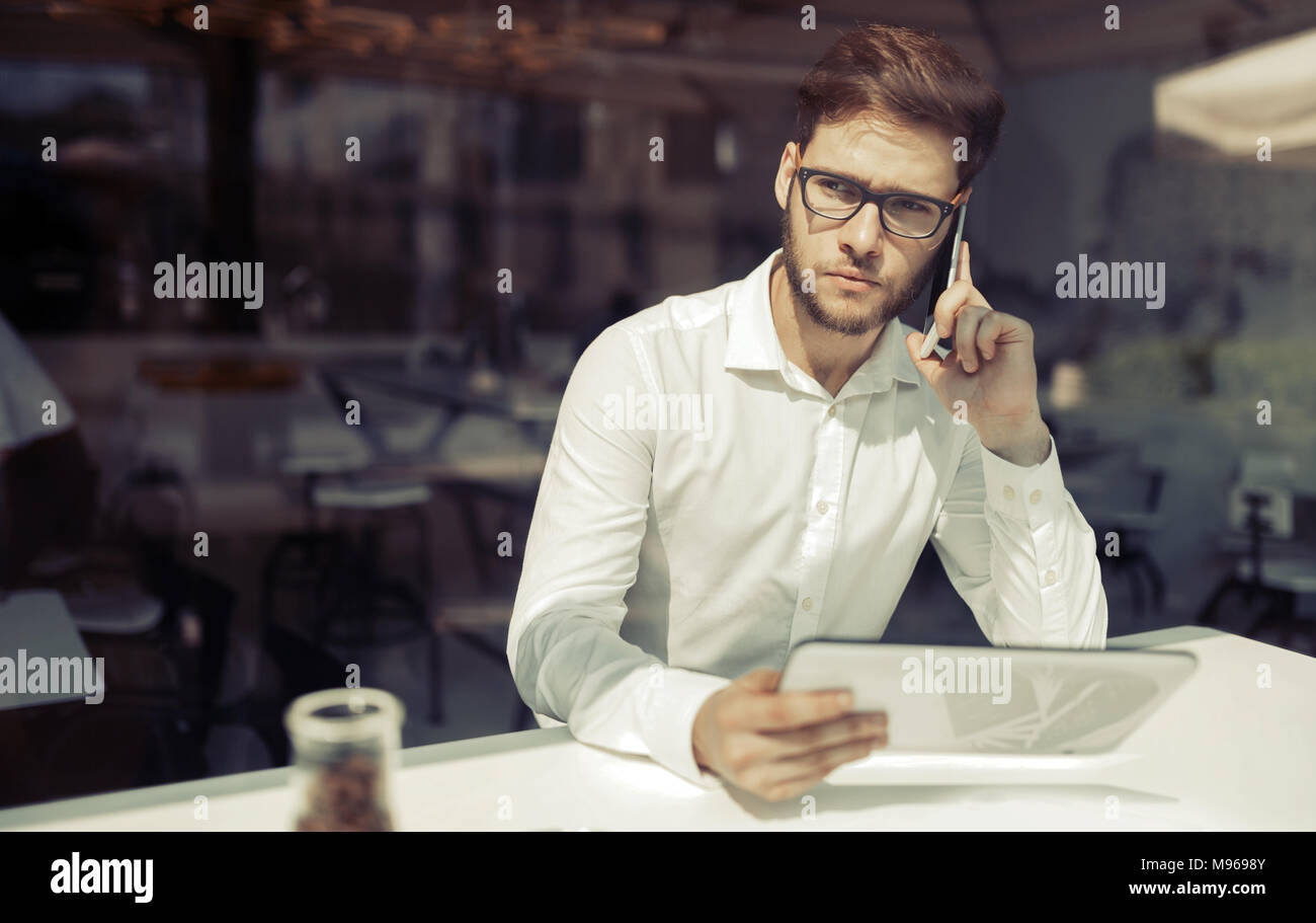 Busy businessman enjoying coffee while online Stock Photo - Alamy
