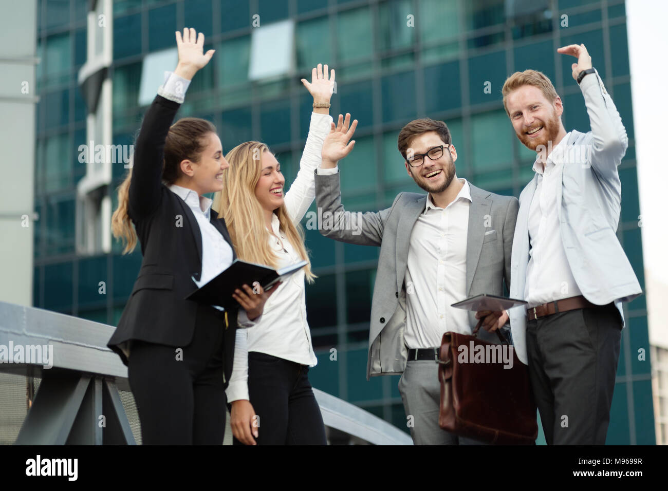 Happy successful business team stand hi-res stock photography and ...