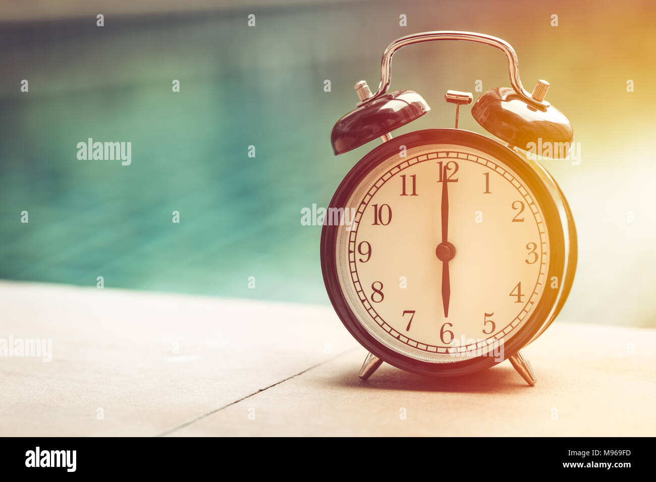 afternoon times clock with blur water park background vintage colortone ...