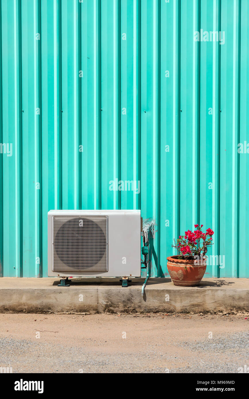 Old compressor air-conditioner and Flower Pot on zinc wall Stock Photo ...