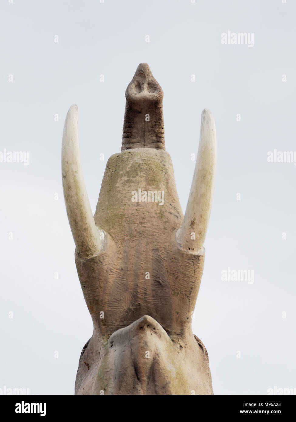 Ant eye view of elephant statue show the lower parts of neck, tusks ...