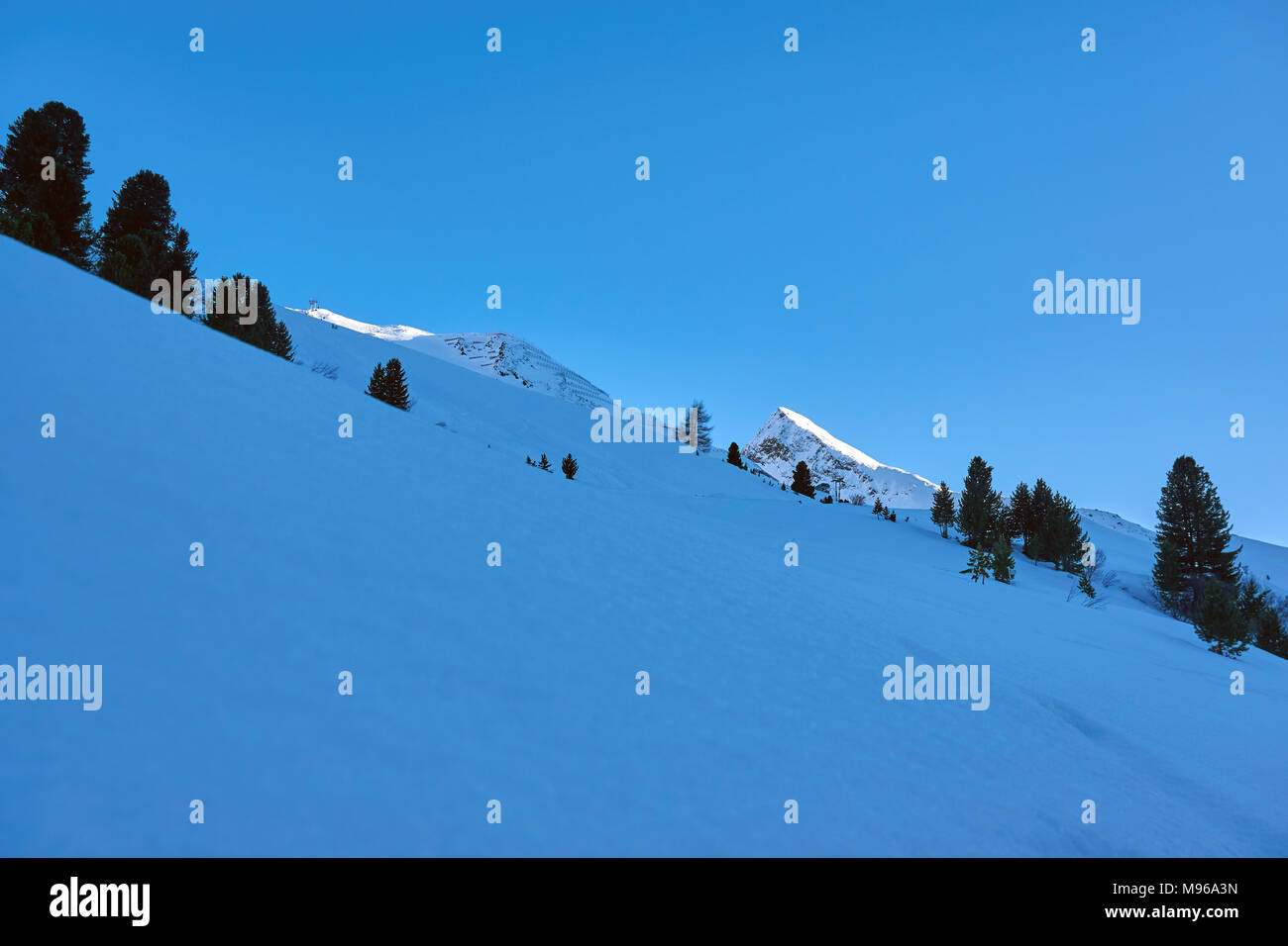 Two mountain peaks, one the 3,020 m Hangerer, catching the last of the ...