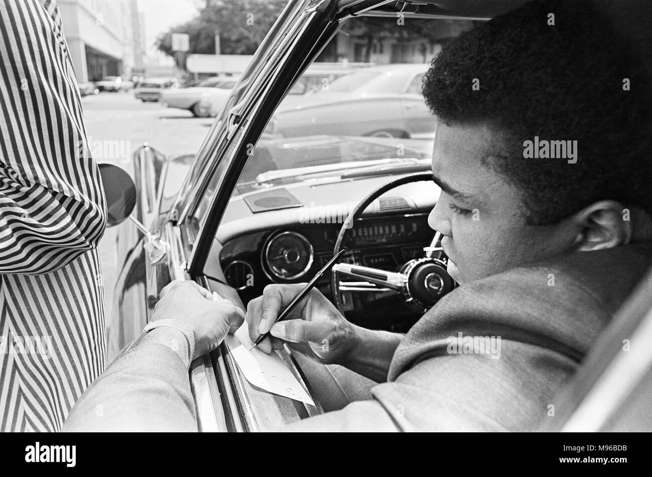 Muhammad Ali signing an autograph for a fan. 31st August 1967 Stock ...