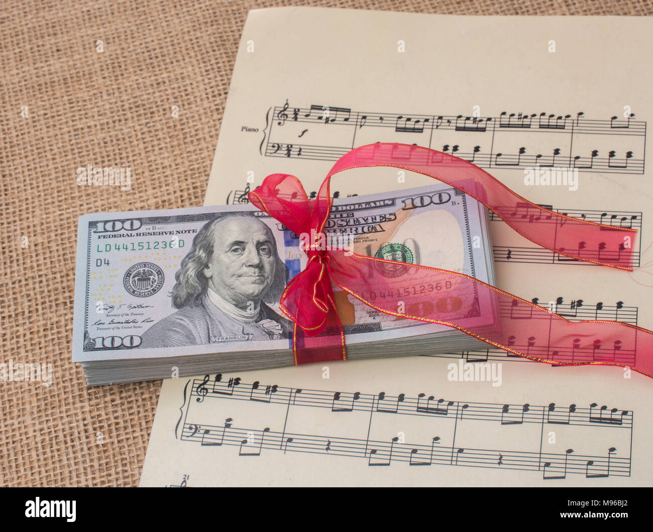 Banknote bundle of US dollar tied with colorful a ribbon Stock Photo ...