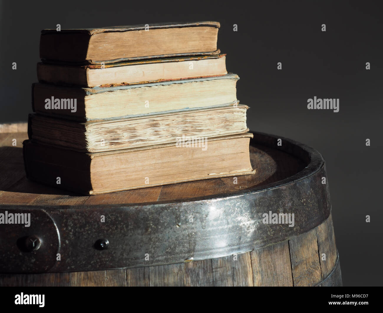 pile of old books on a whiskey barrel Stock Photo - Alamy