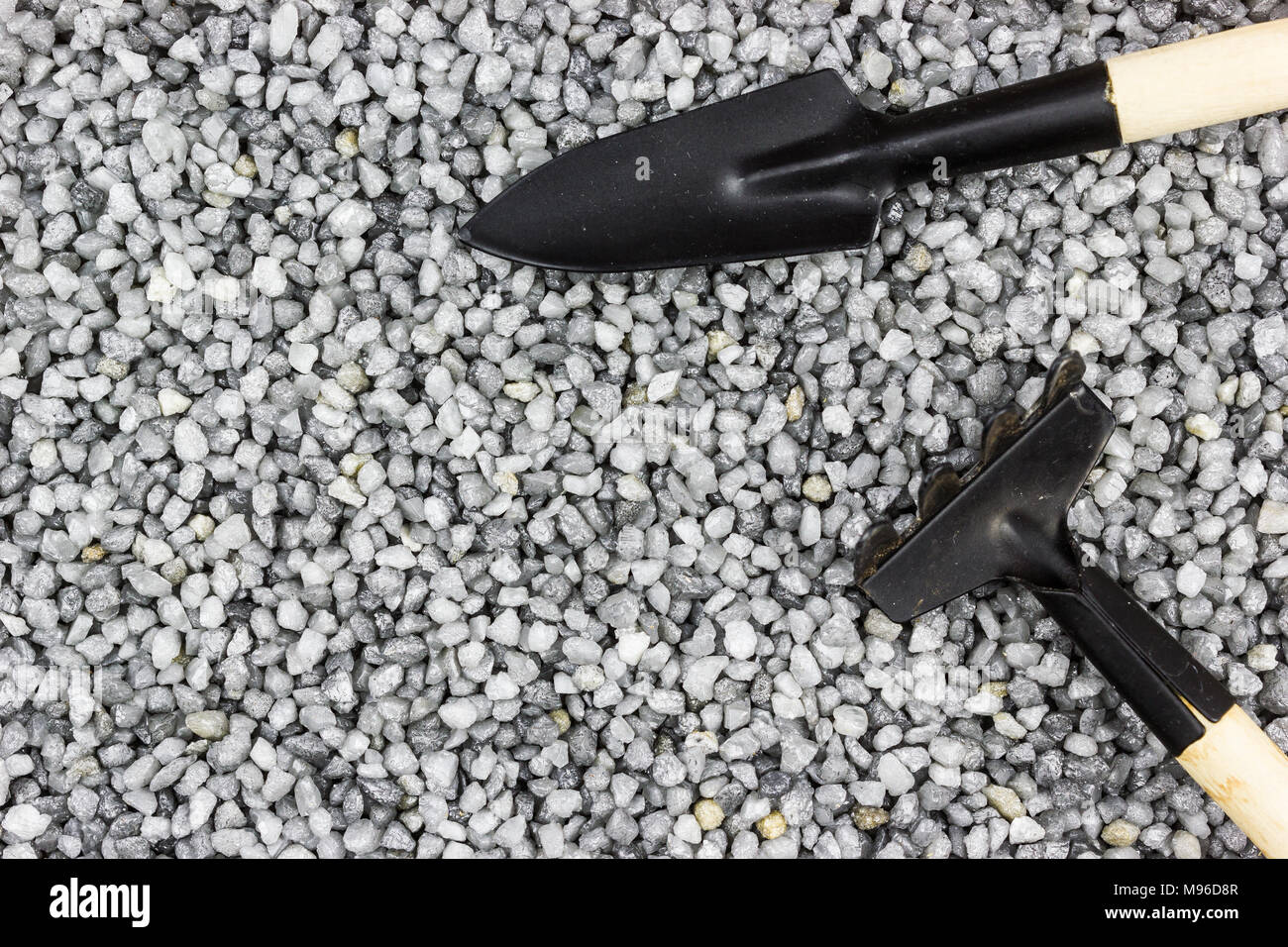 Garden tools on gravel. A shovel and a rake on the ground. Gardening ...