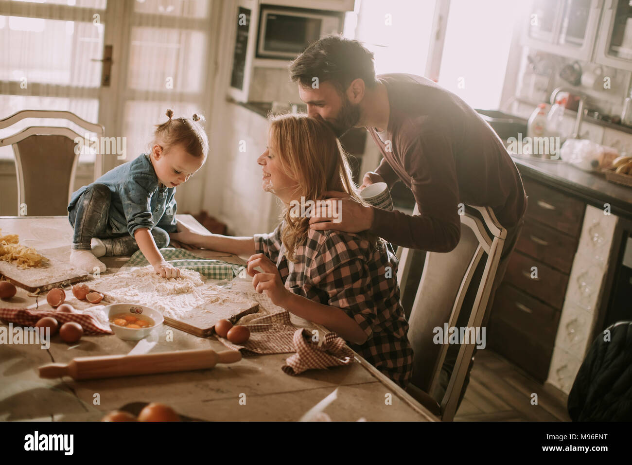 Happy family making pasta in the kitchen at home Stock Photo - Alamy