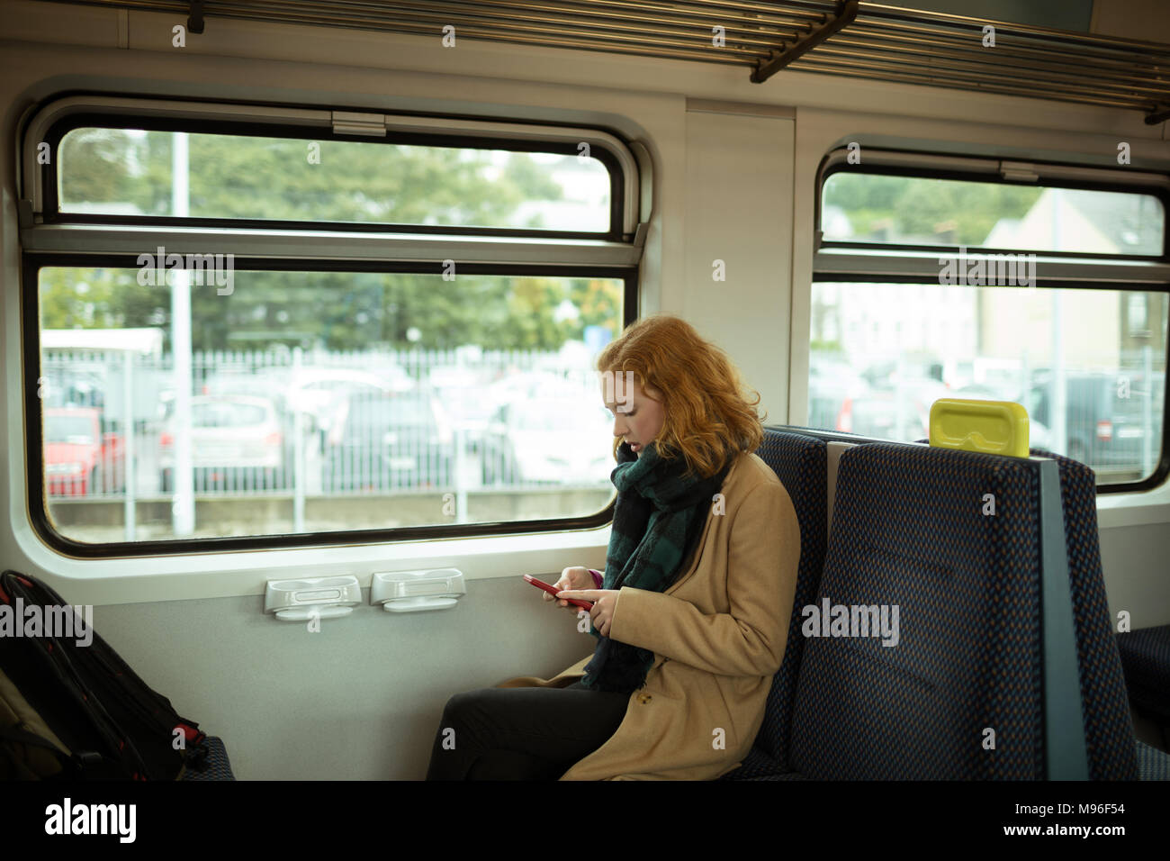 Beautiful woman using red smartphone hi-res stock photography and ...