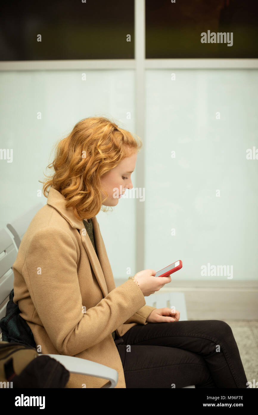 Woman using mobile phone while travelling in train Stock Photo - Alamy