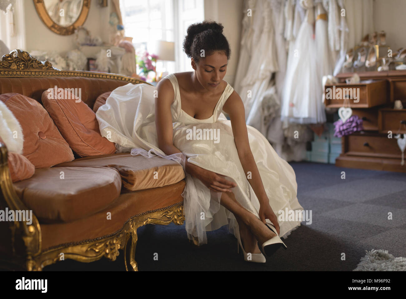 Young bride in wedding dress wearing high heels Stock Photo - Alamy