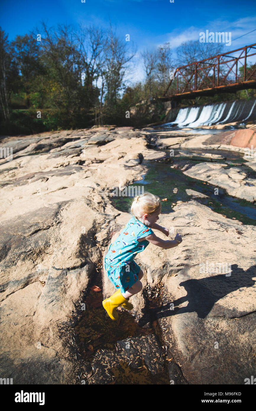 Girl playing on rocks Stock Photo - Alamy