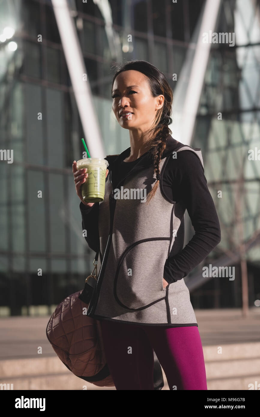 Woman having drink on street Stock Photo - Alamy