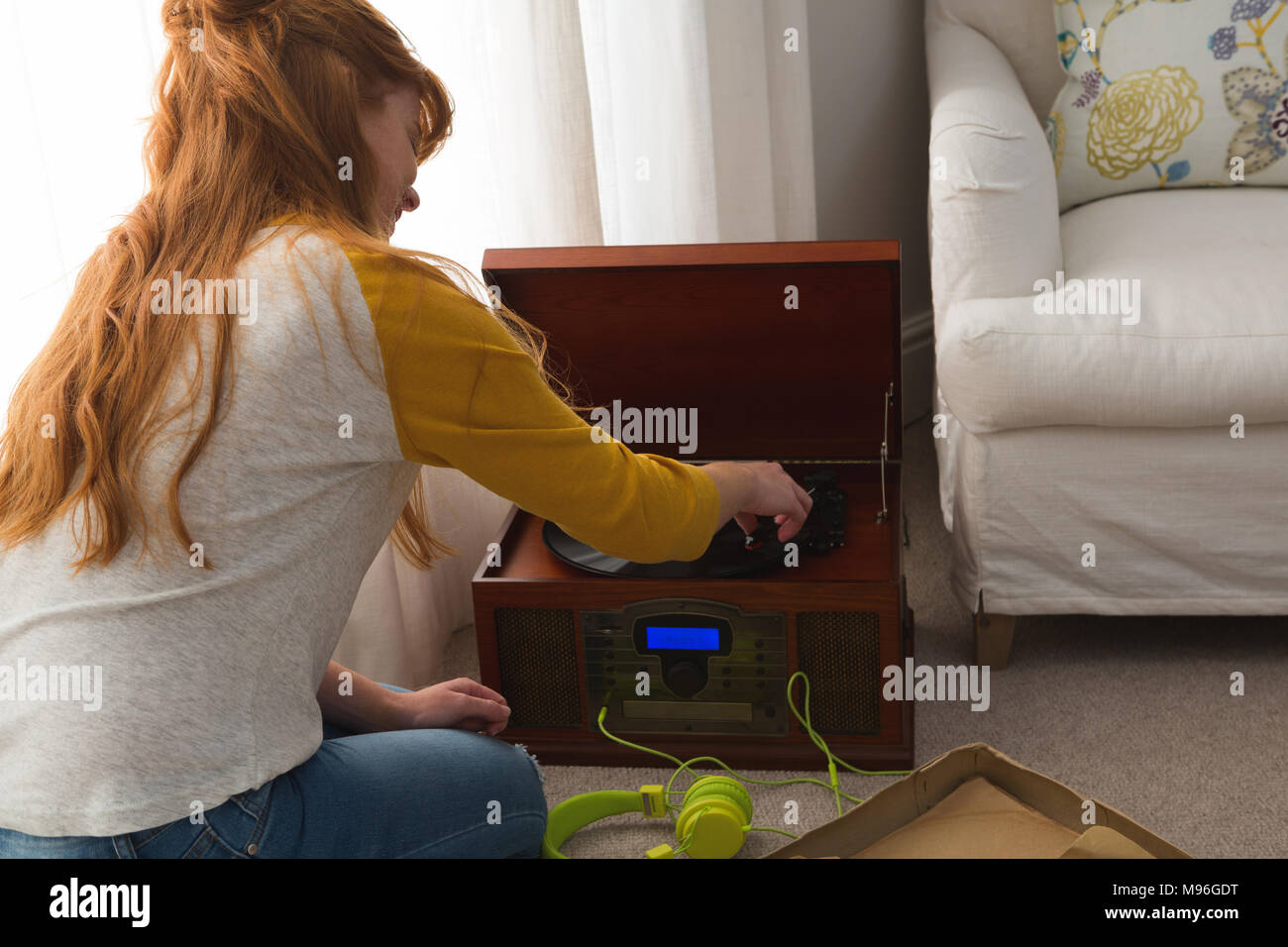 Woman playing a gramophone at home Stock Photo - Alamy