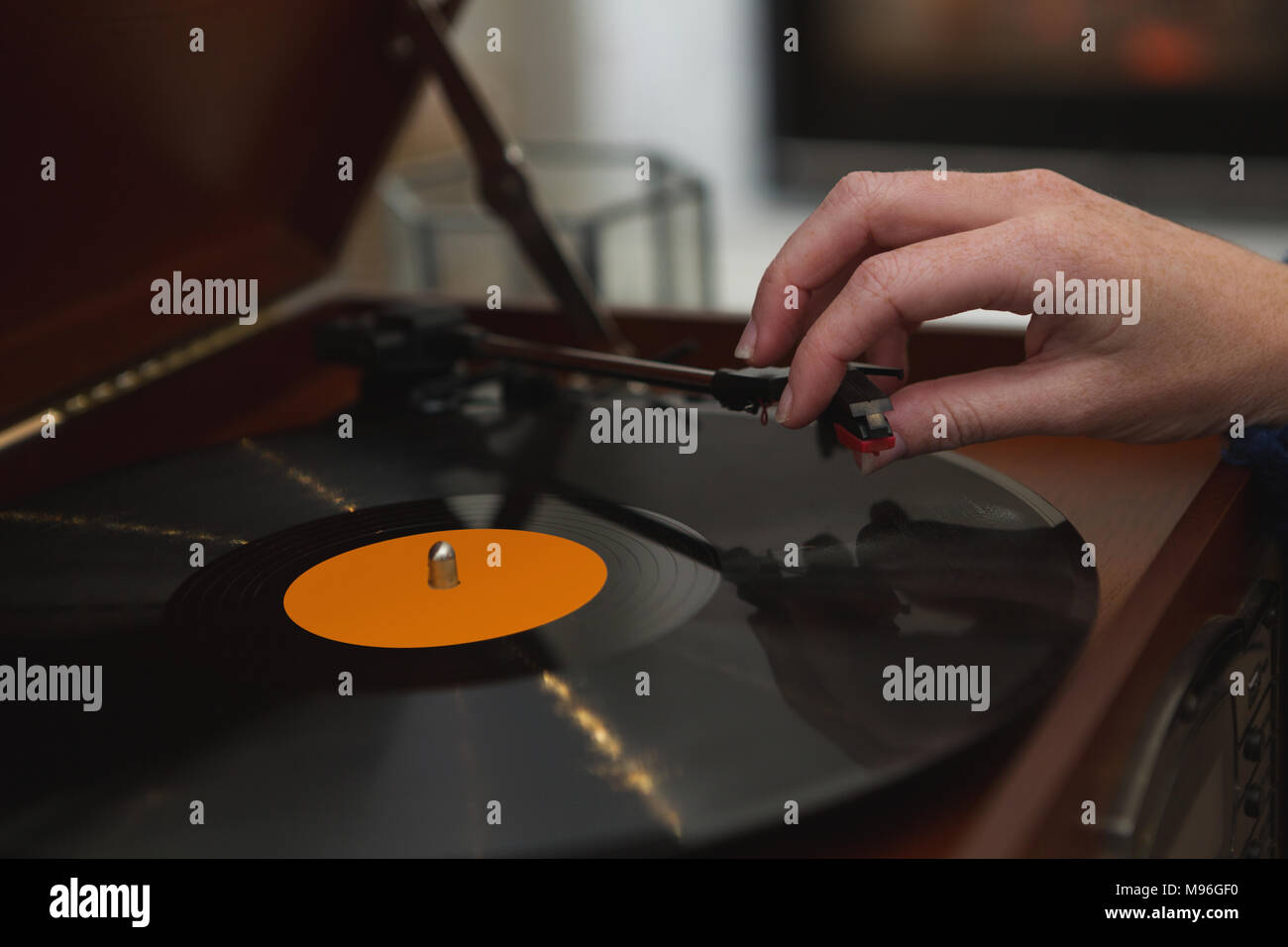 Woman playing a gramophone at home Stock Photo - Alamy