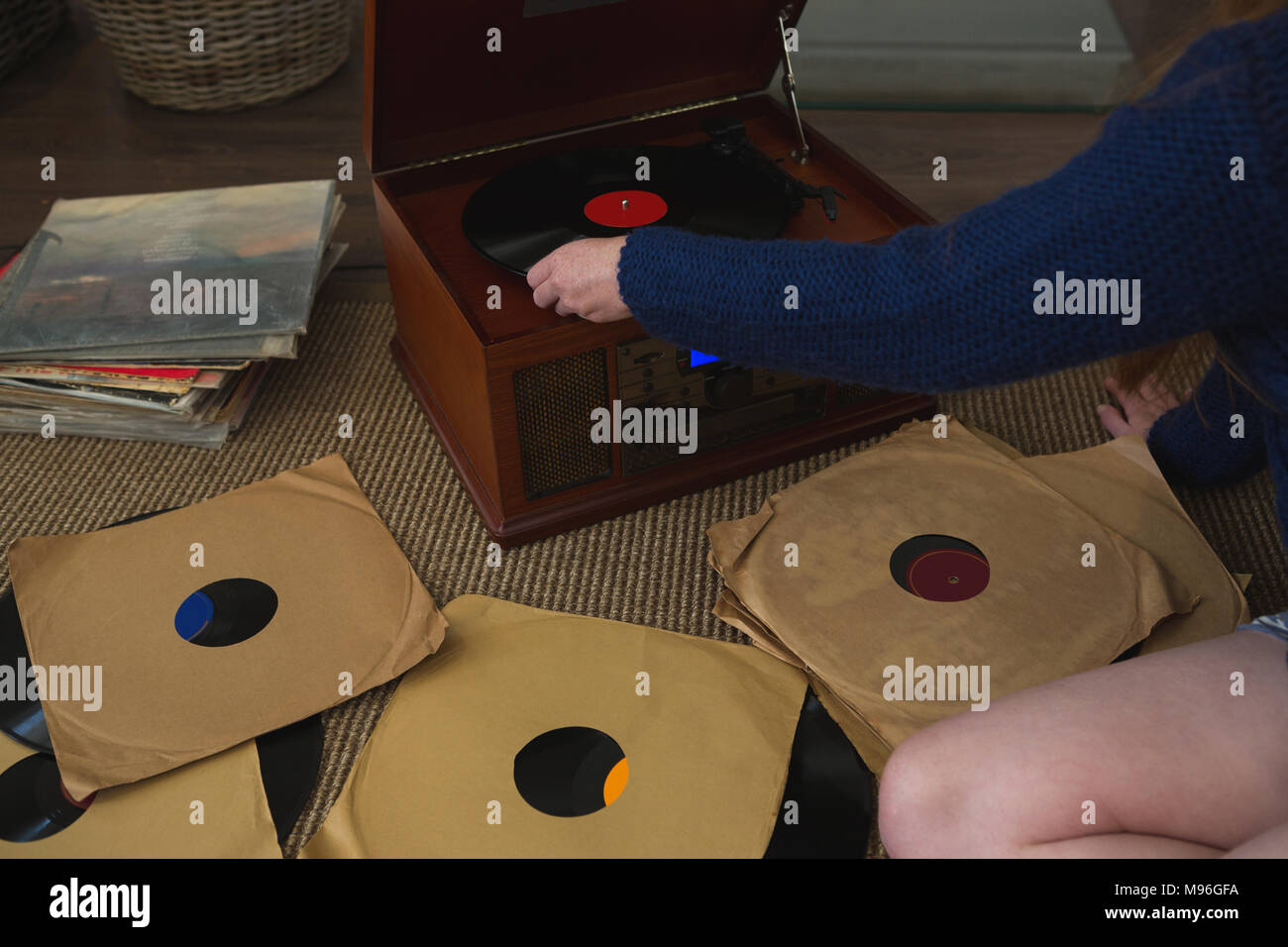 Woman playing a gramophone at home Stock Photo - Alamy