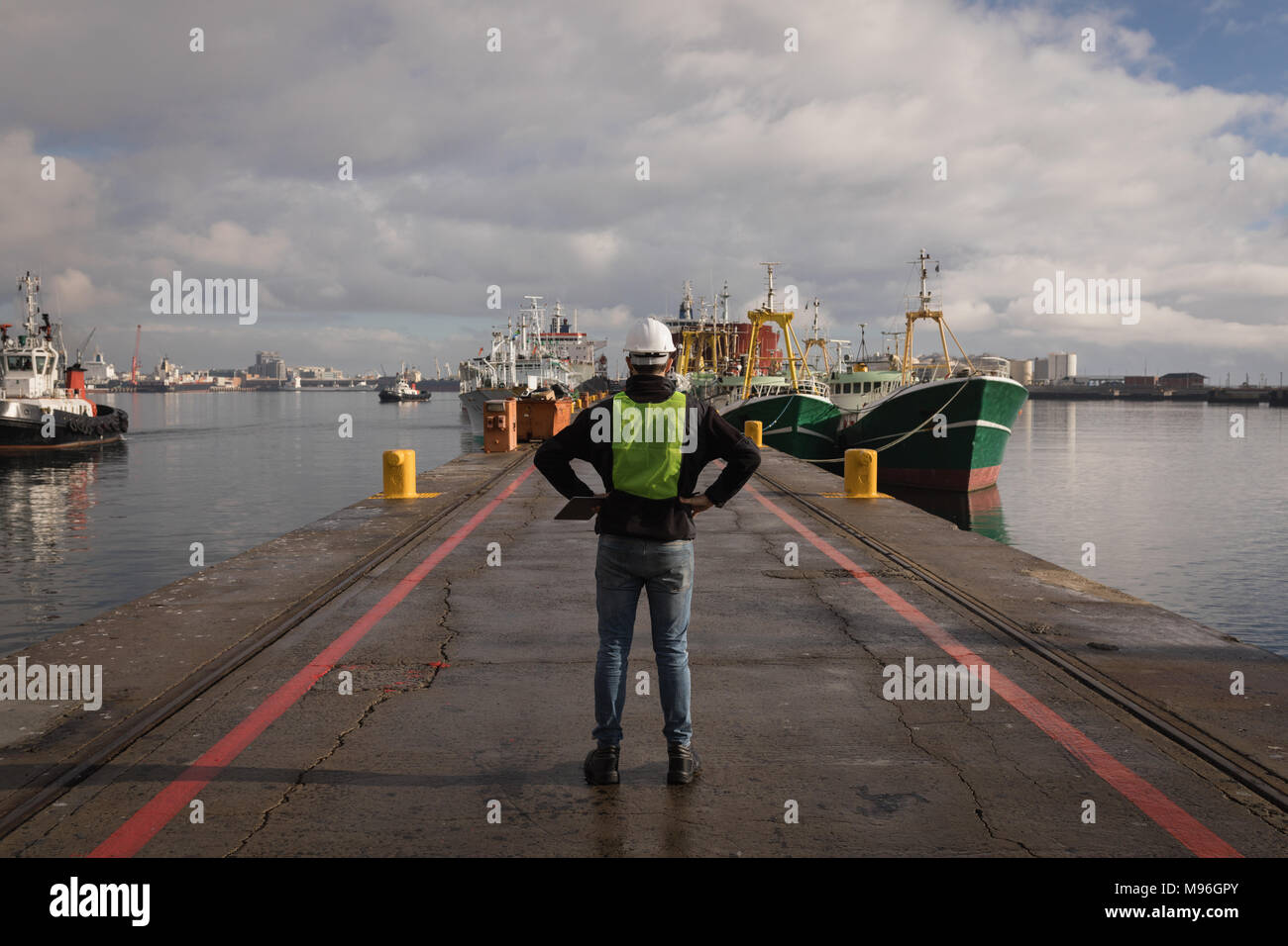 Dock worker standing in the port Stock Photo - Alamy