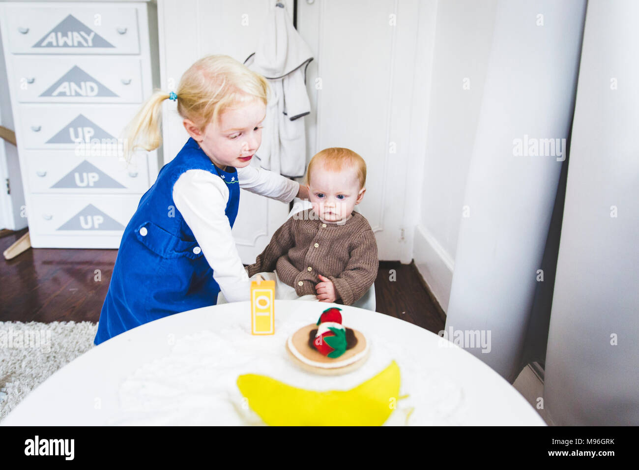 Baby girl eating table hi-res stock photography and images - Alamy
