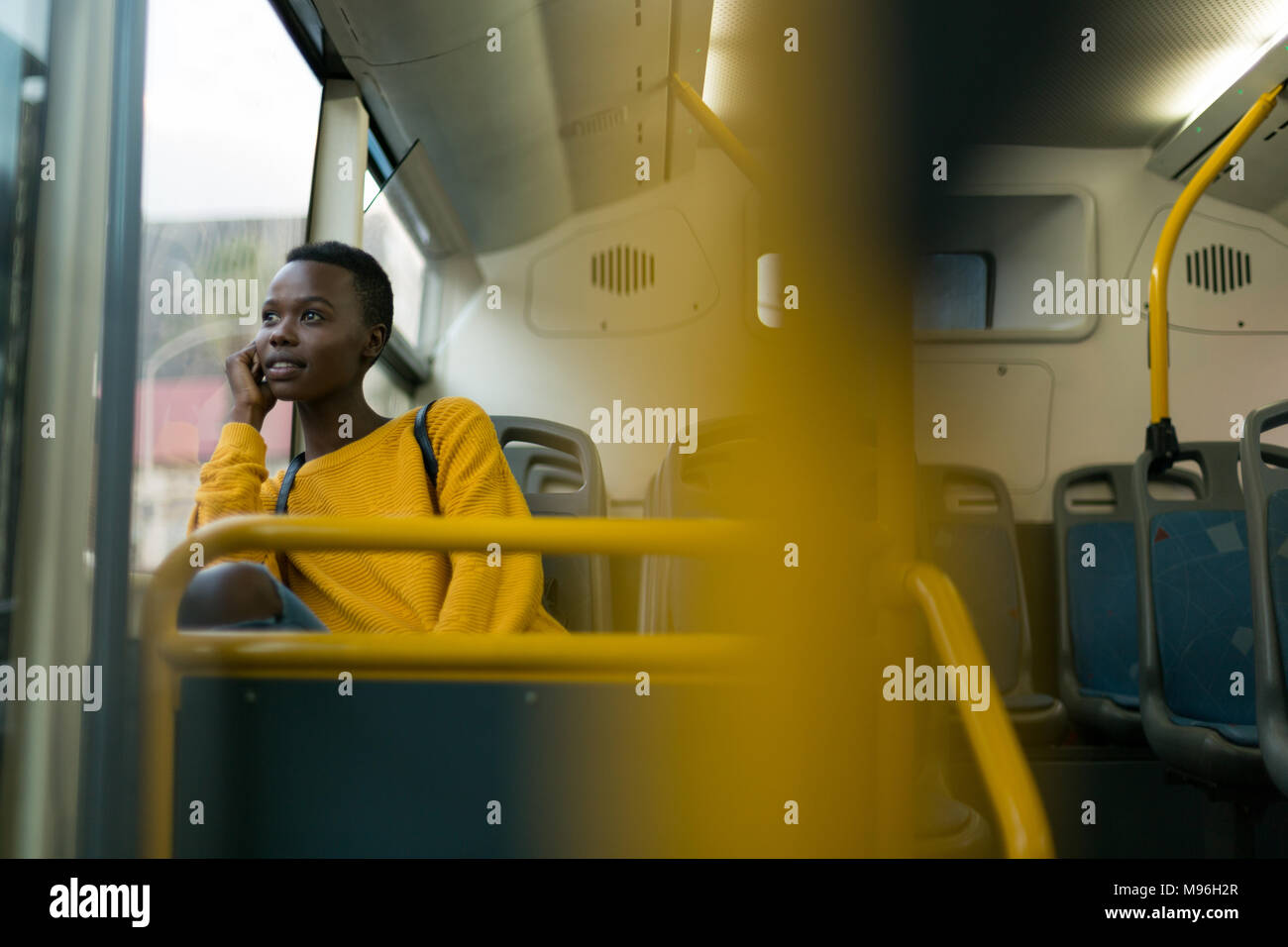 Woman looking through window while travelling in bus Stock Photo - Alamy