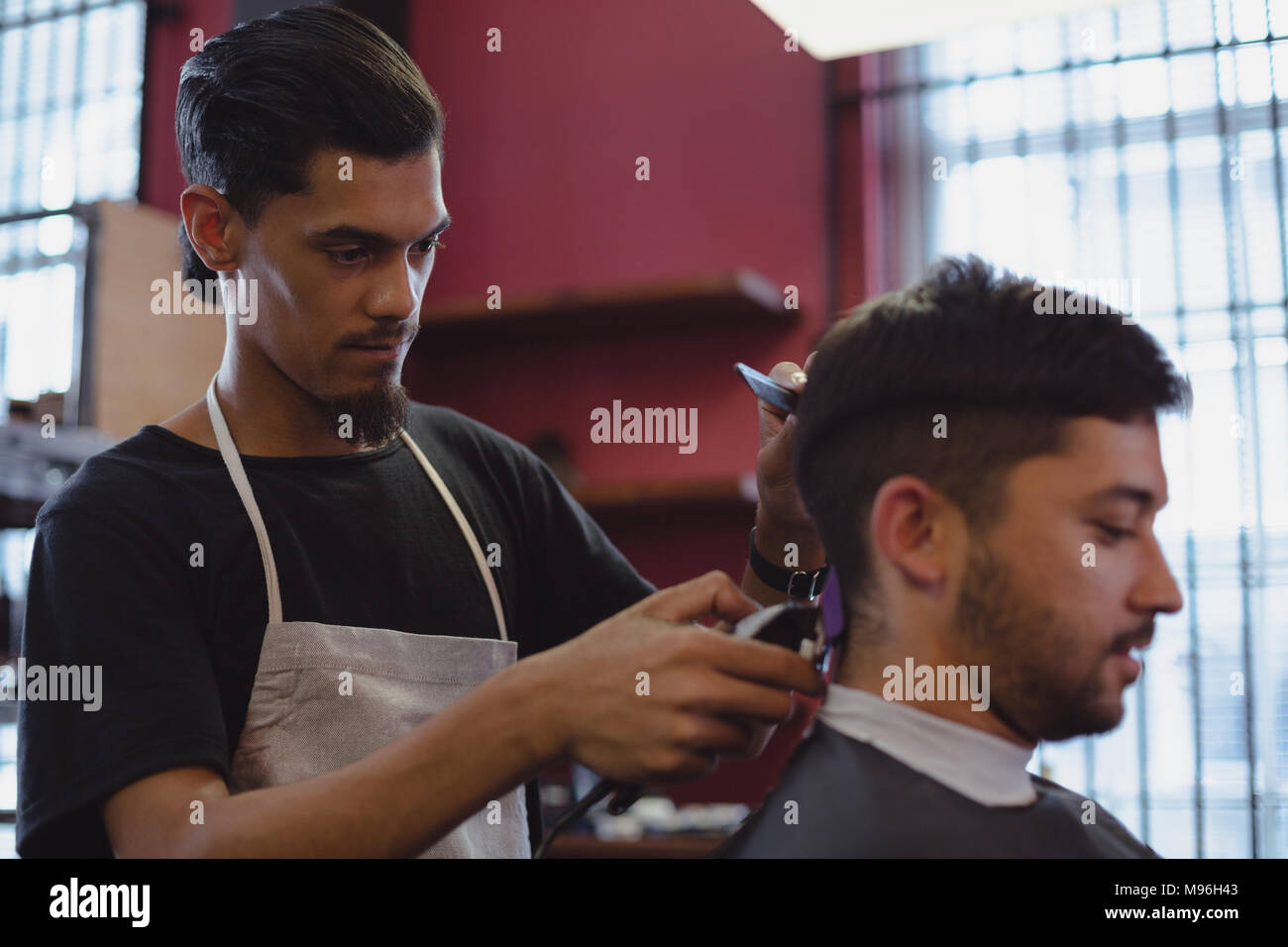 Man getting his hair trimmed with trimmer Stock Photo - Alamy