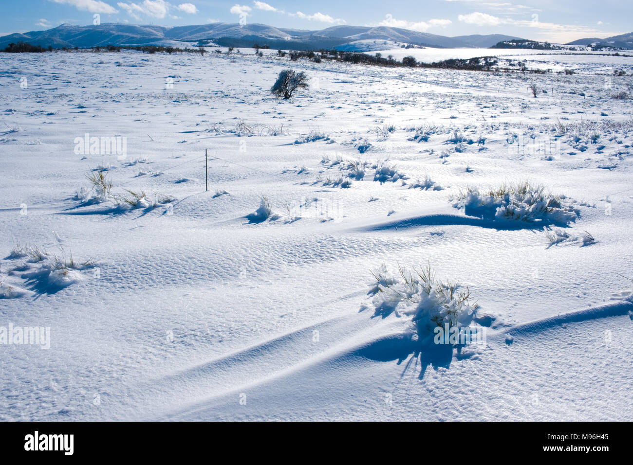 scenic winters view across windswept and snow covered fields high up in ...