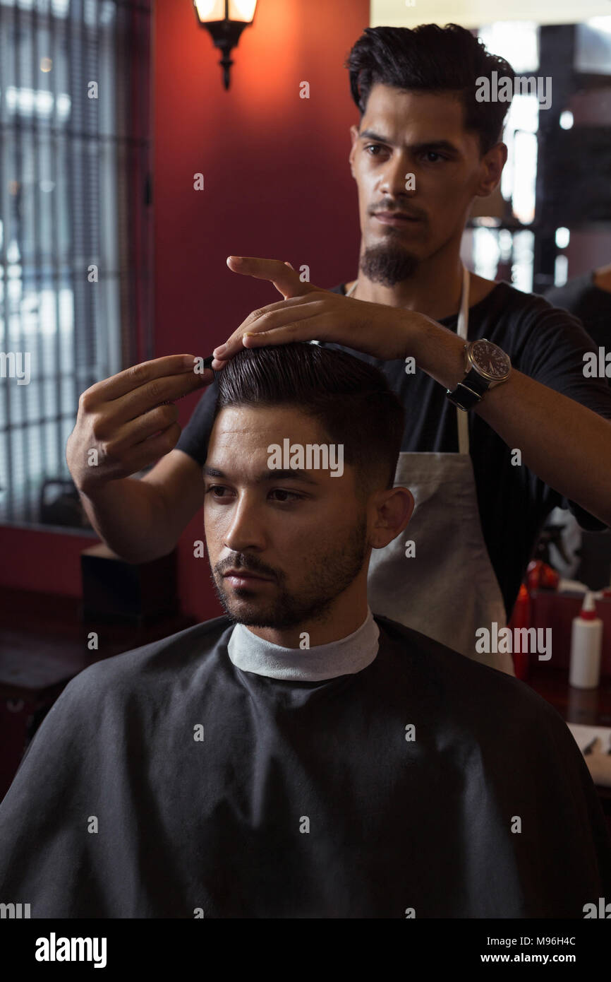Man getting his hair trimmed with scissor Stock Photo - Alamy