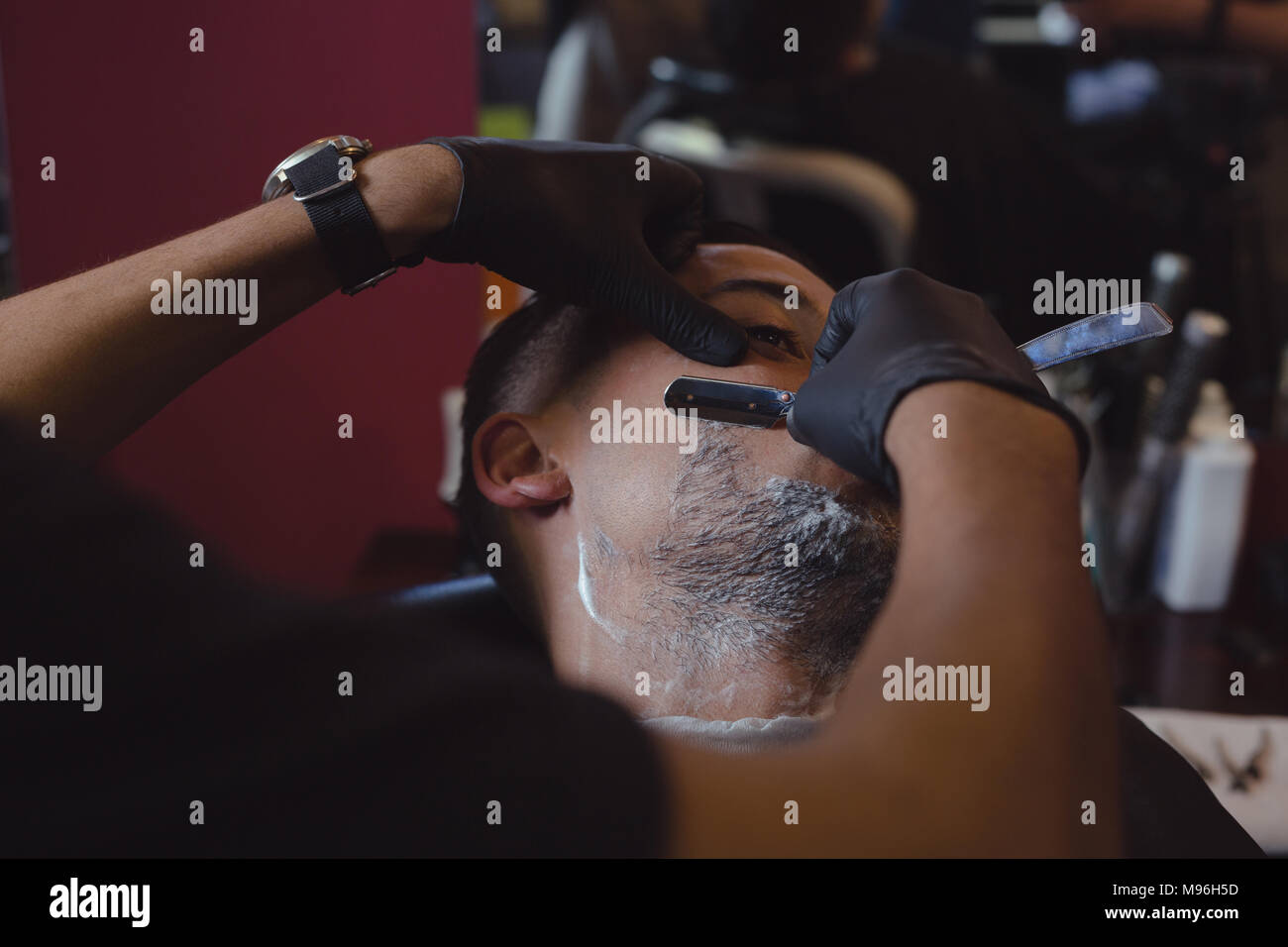 Man getting his beard shaved with straight razor Stock Photo - Alamy