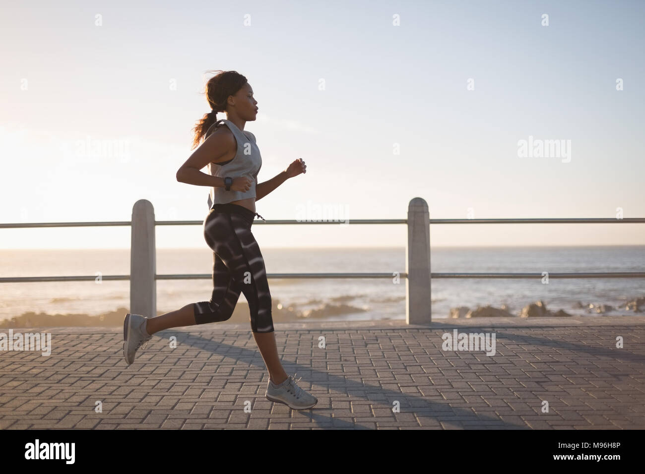 Woman jogging near beach hi-res stock photography and images - Alamy