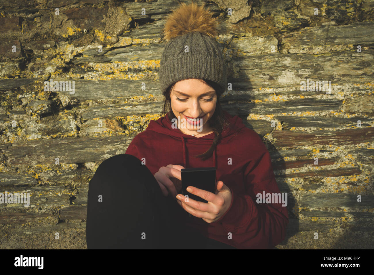 Young female texting cellphone against hi-res stock photography and ...