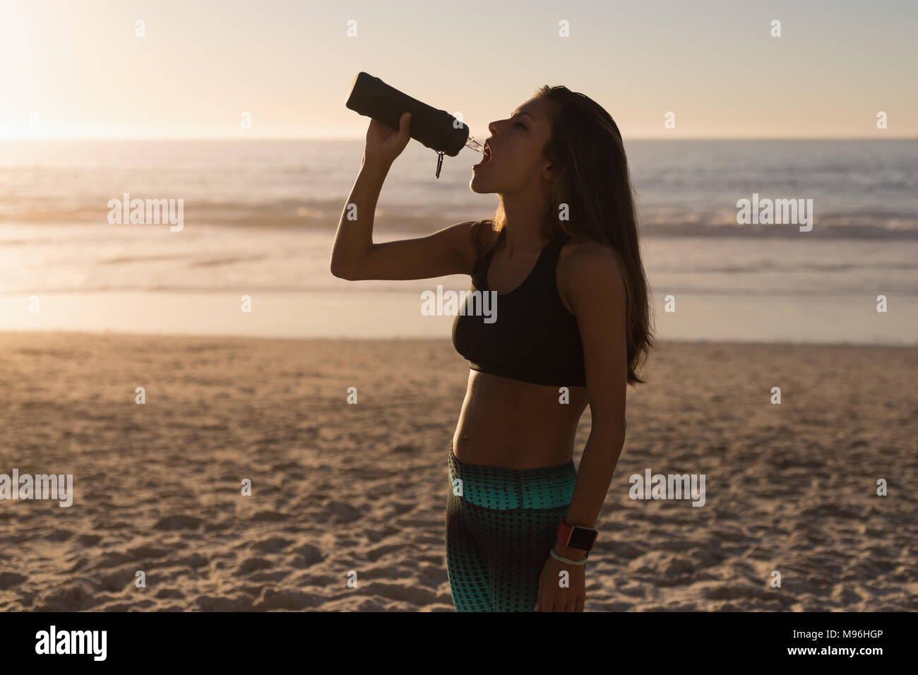 Beautiful woman water bottle beach hi-res stock photography and images ...