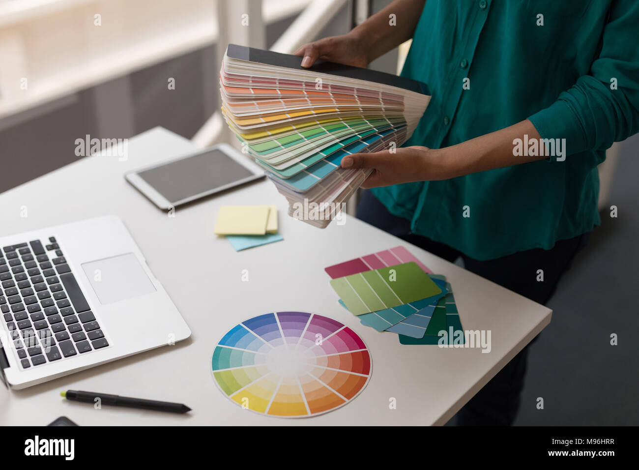 Female graphic designer holding color shade cards Stock Photo - Alamy