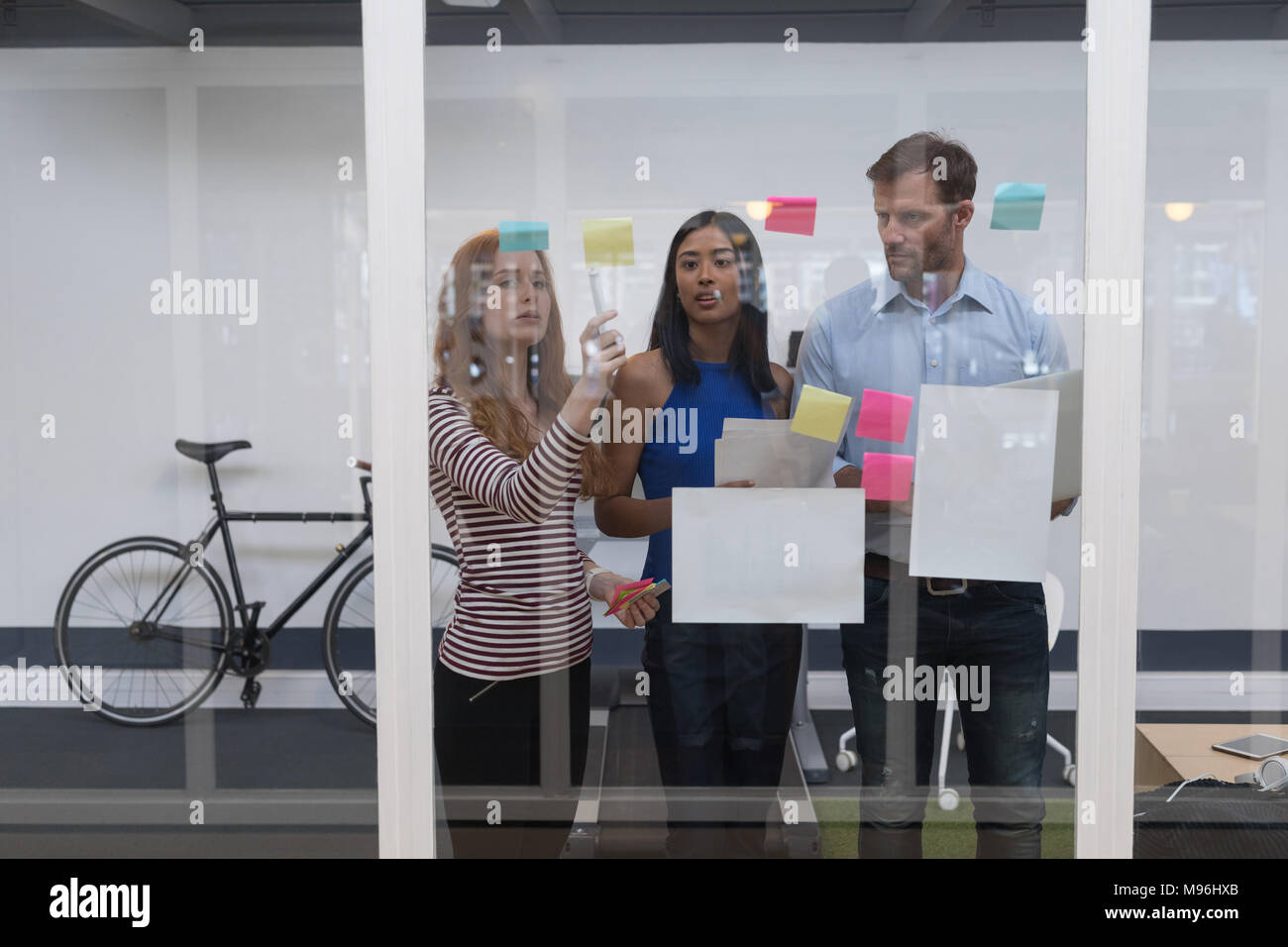 Business colleagues discussing over sticky notes Stock Photo - Alamy