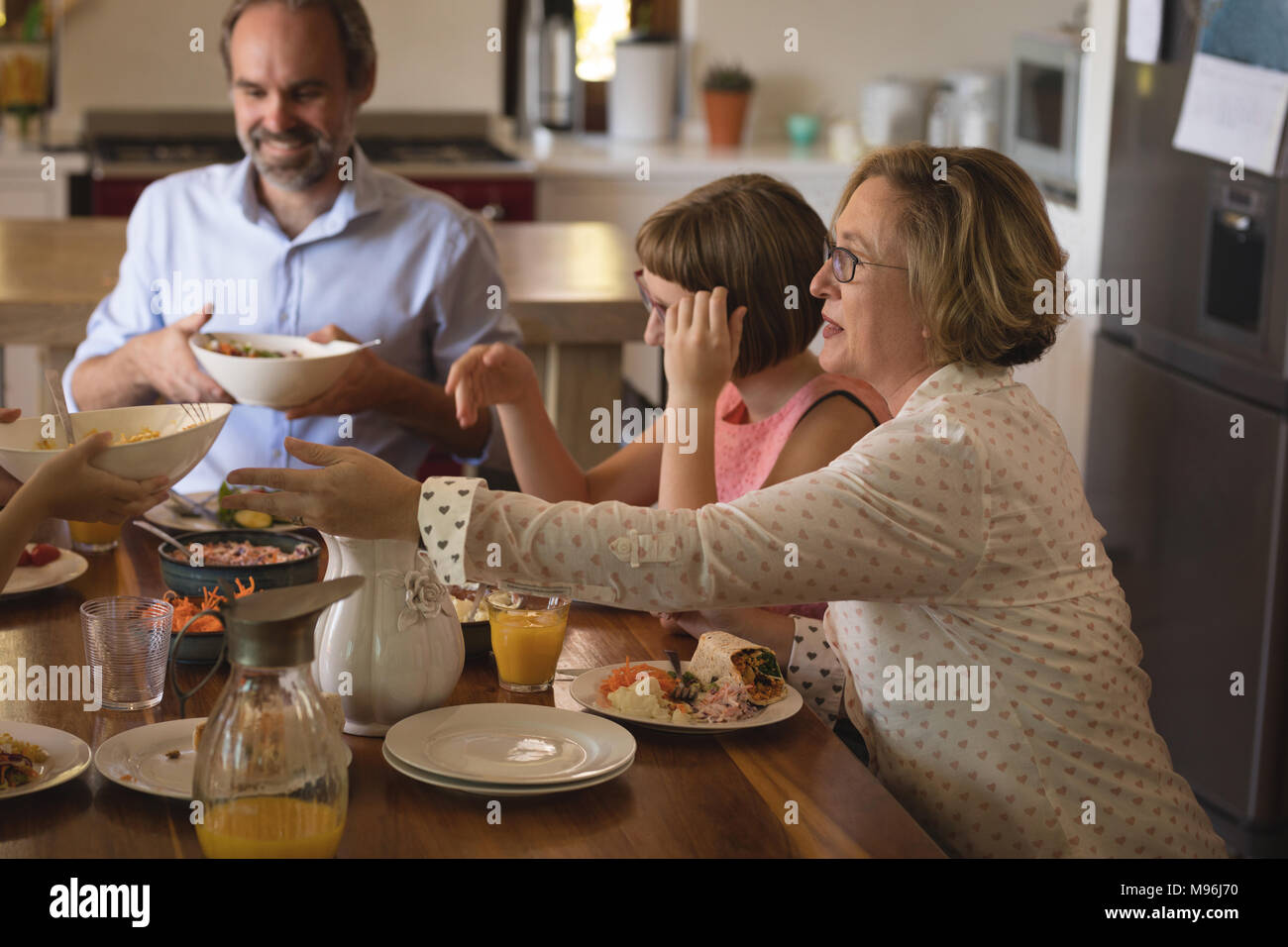 Family having lunch in kitchen Stock Photo - Alamy