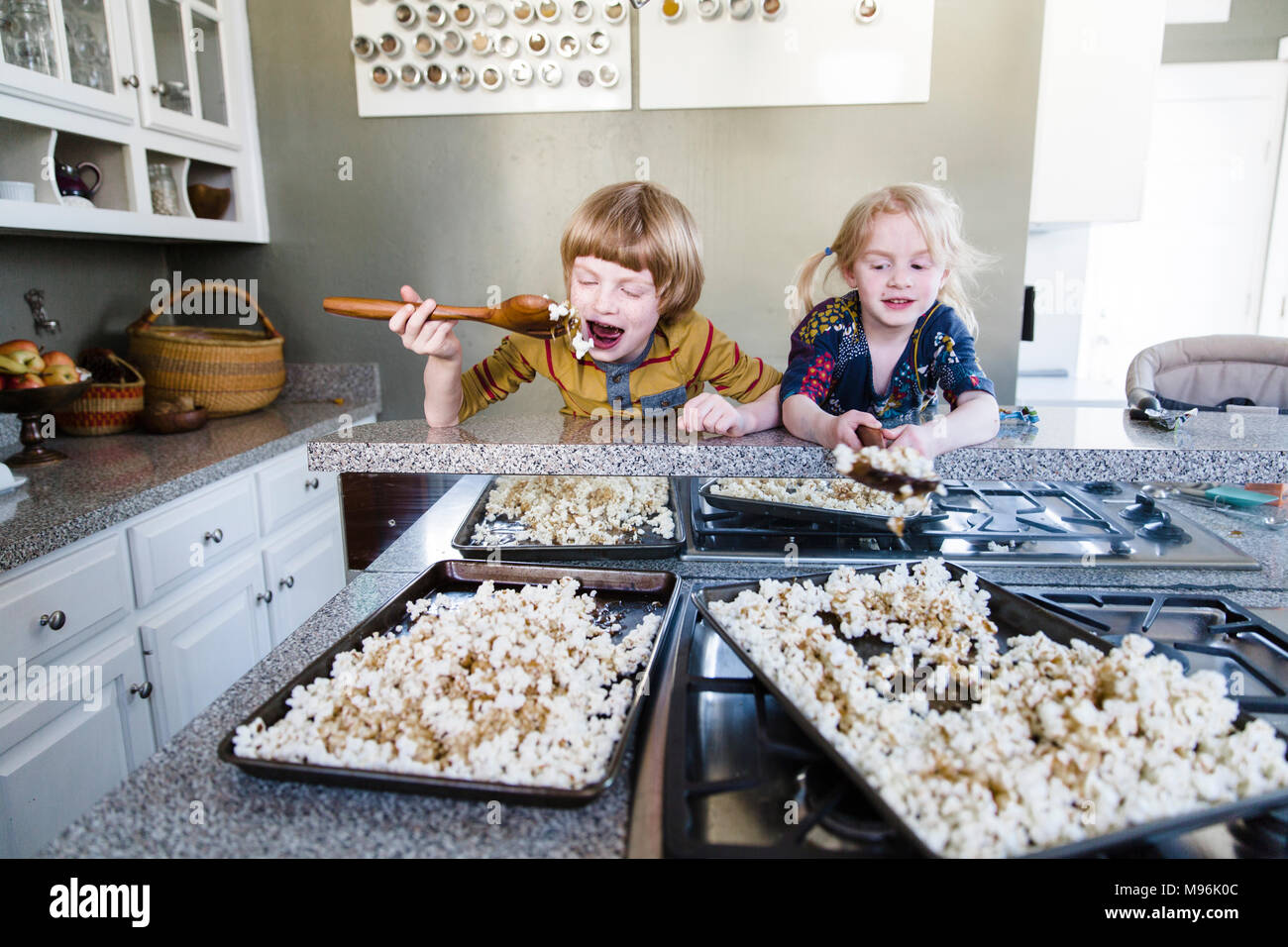 Children eating popcorn from tray Stock Photo - Alamy