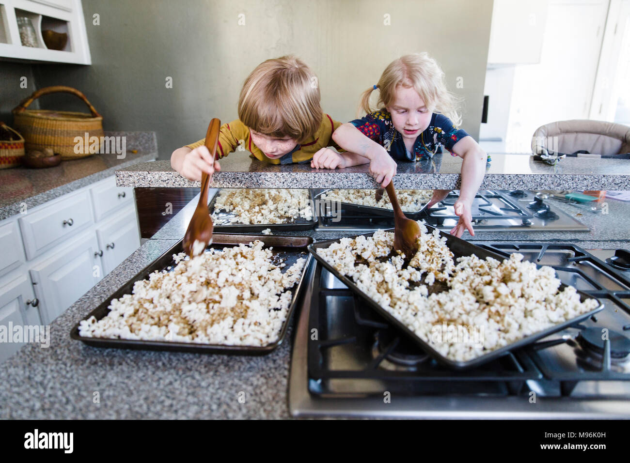 Children picking up popcorn from tray Stock Photo - Alamy