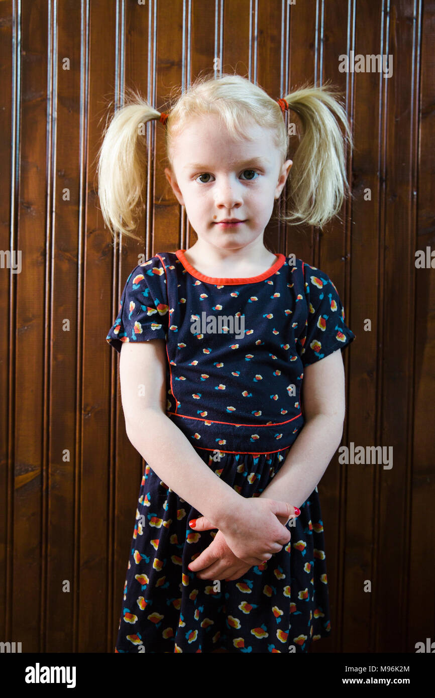 Girl with pigtails pulling faces Stock Photo - Alamy