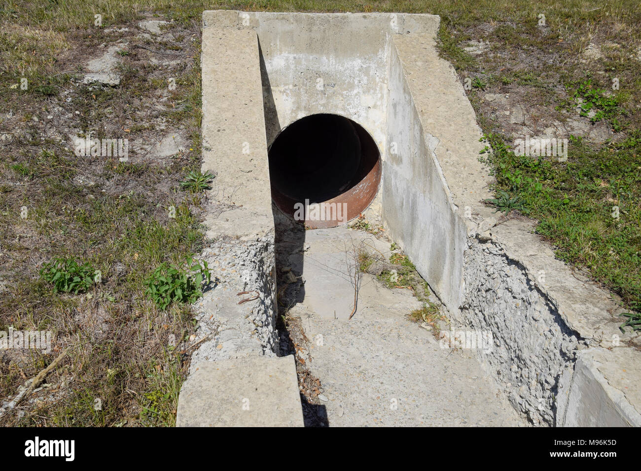 Tunnel for draining rainwater under the road. View through the pipe ...