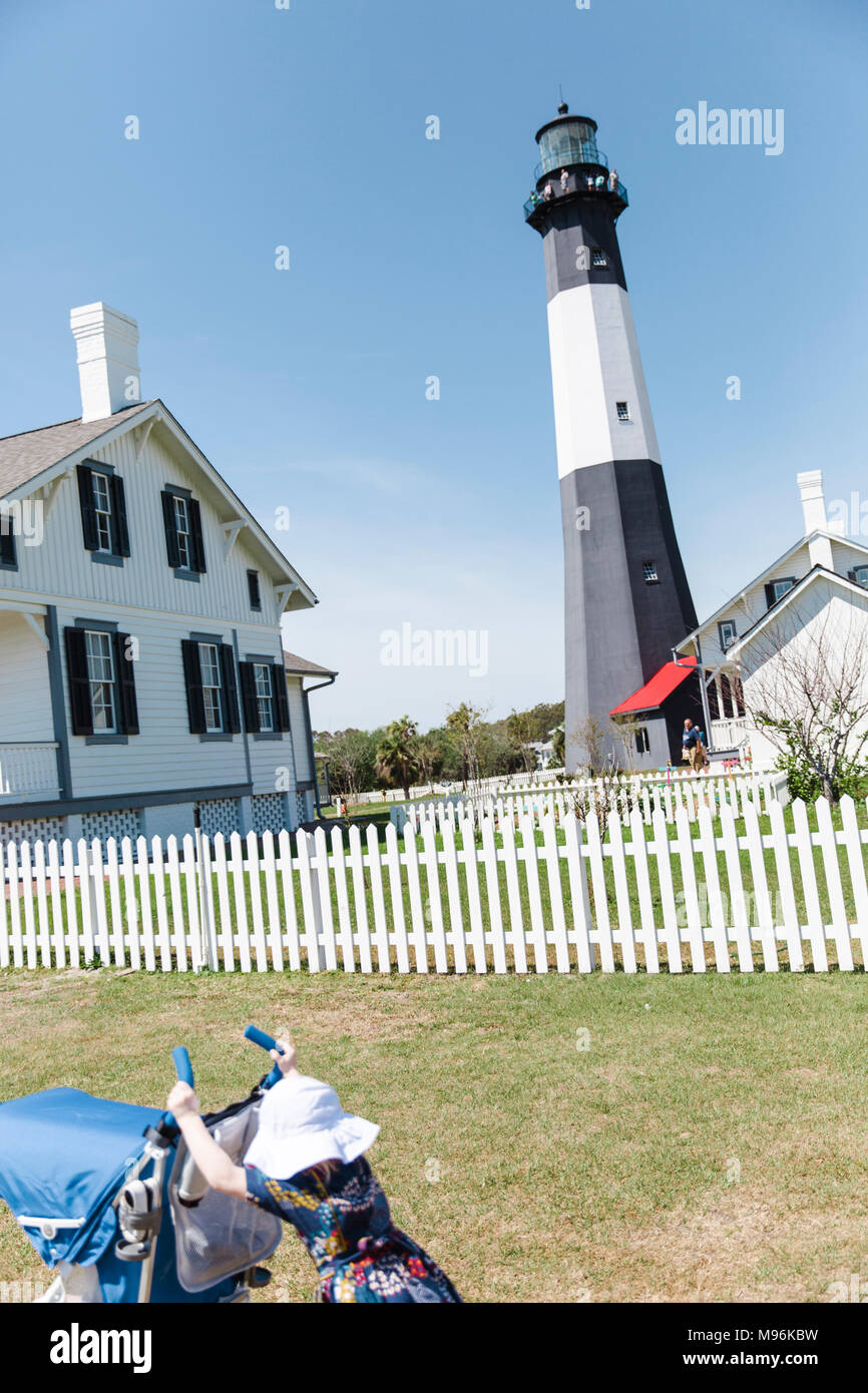 Family outside next to white fence and lighthouse Stock Photo - Alamy