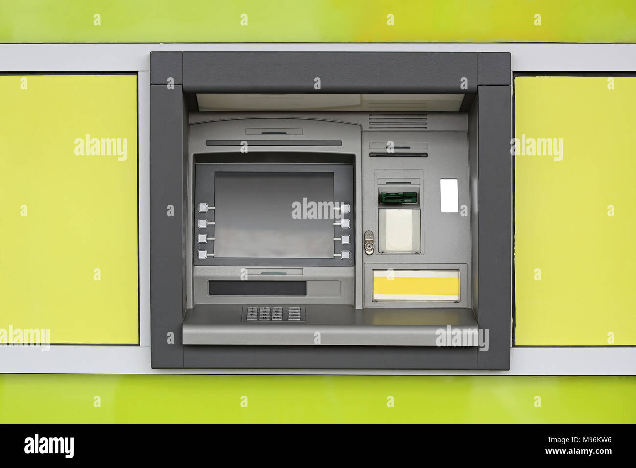 Automated Teller Machine Bank at Yellow Wall Stock Photo - Alamy