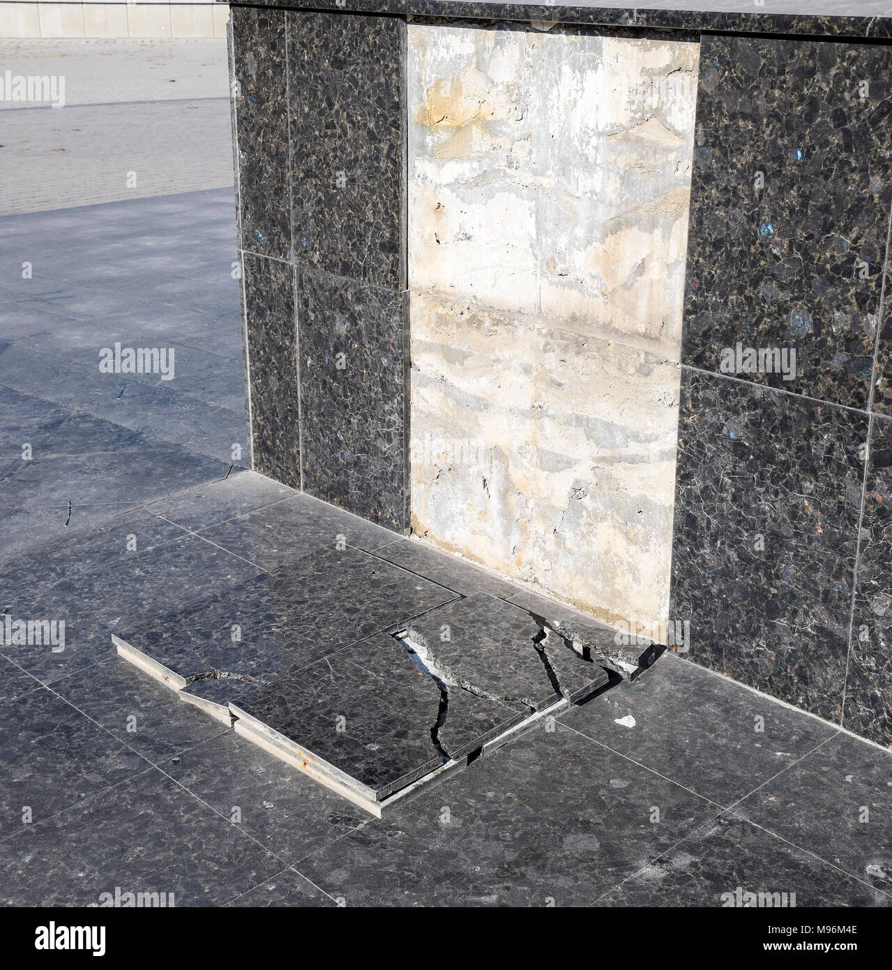 The ruined marble tile that fell off from the base of the monument ...