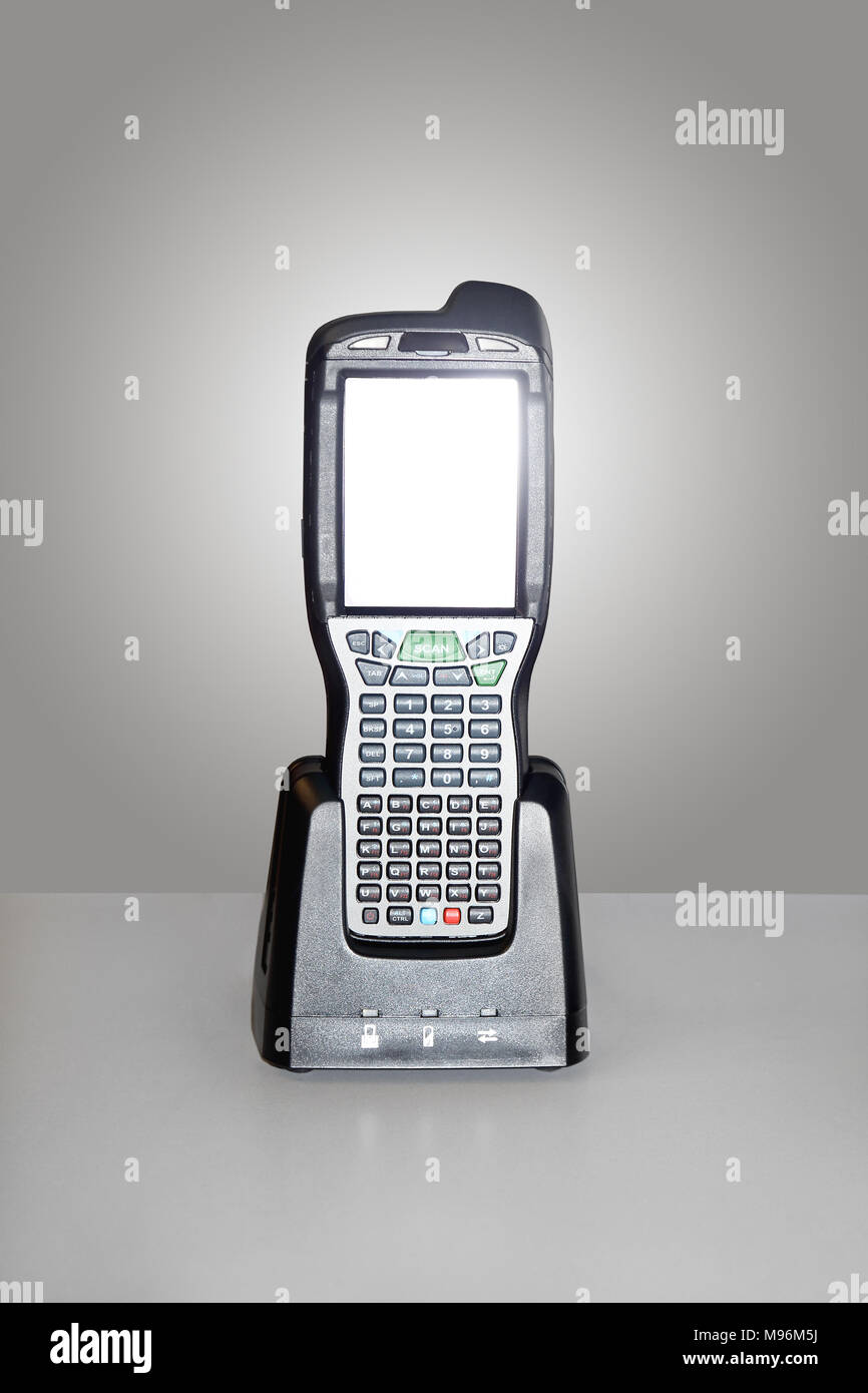 Handheld Laser Barcode Scanner Computer at Charger Dock Stock Photo - Alamy