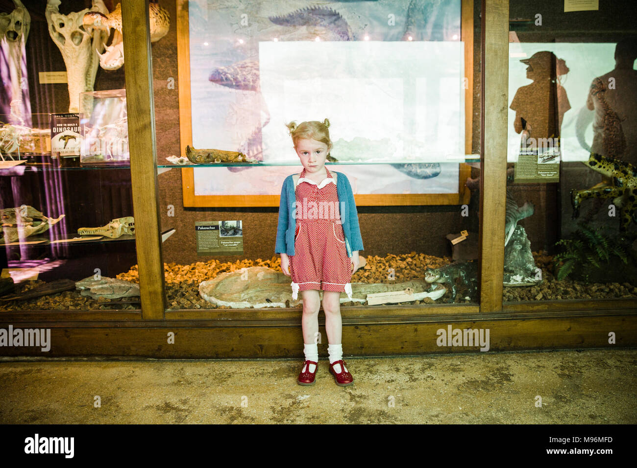 Girl standing next to museum exhibit Stock Photo - Alamy