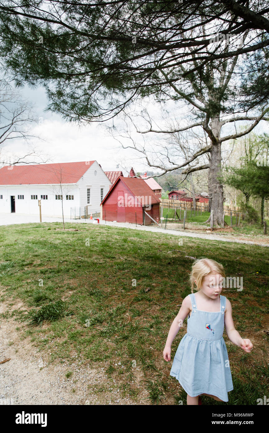 Girl standing outside of barn Stock Photo - Alamy